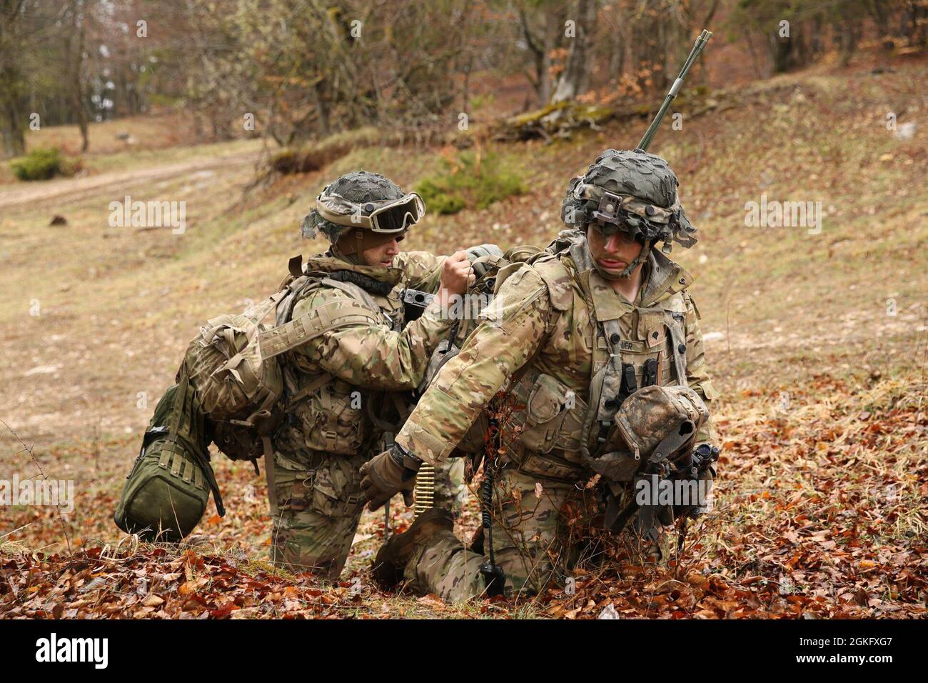 A U.S. Army Soldier with 2nd Cavalry Regiment, Red Platoon, assists a ...