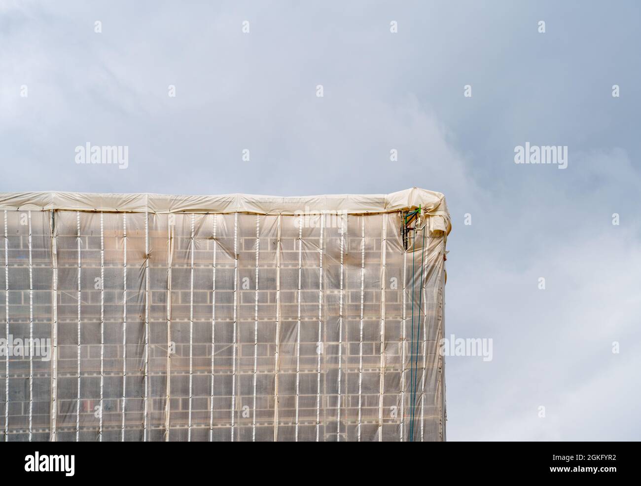 Building covered in plastic for renovations Stock Photo - Alamy