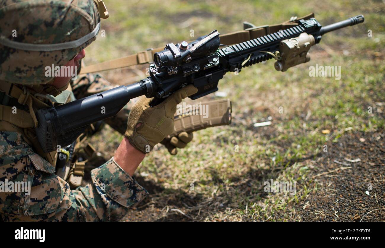 A U.S. Marine with 3d Battalion, 3d Marines, conducts a tactical reload ...