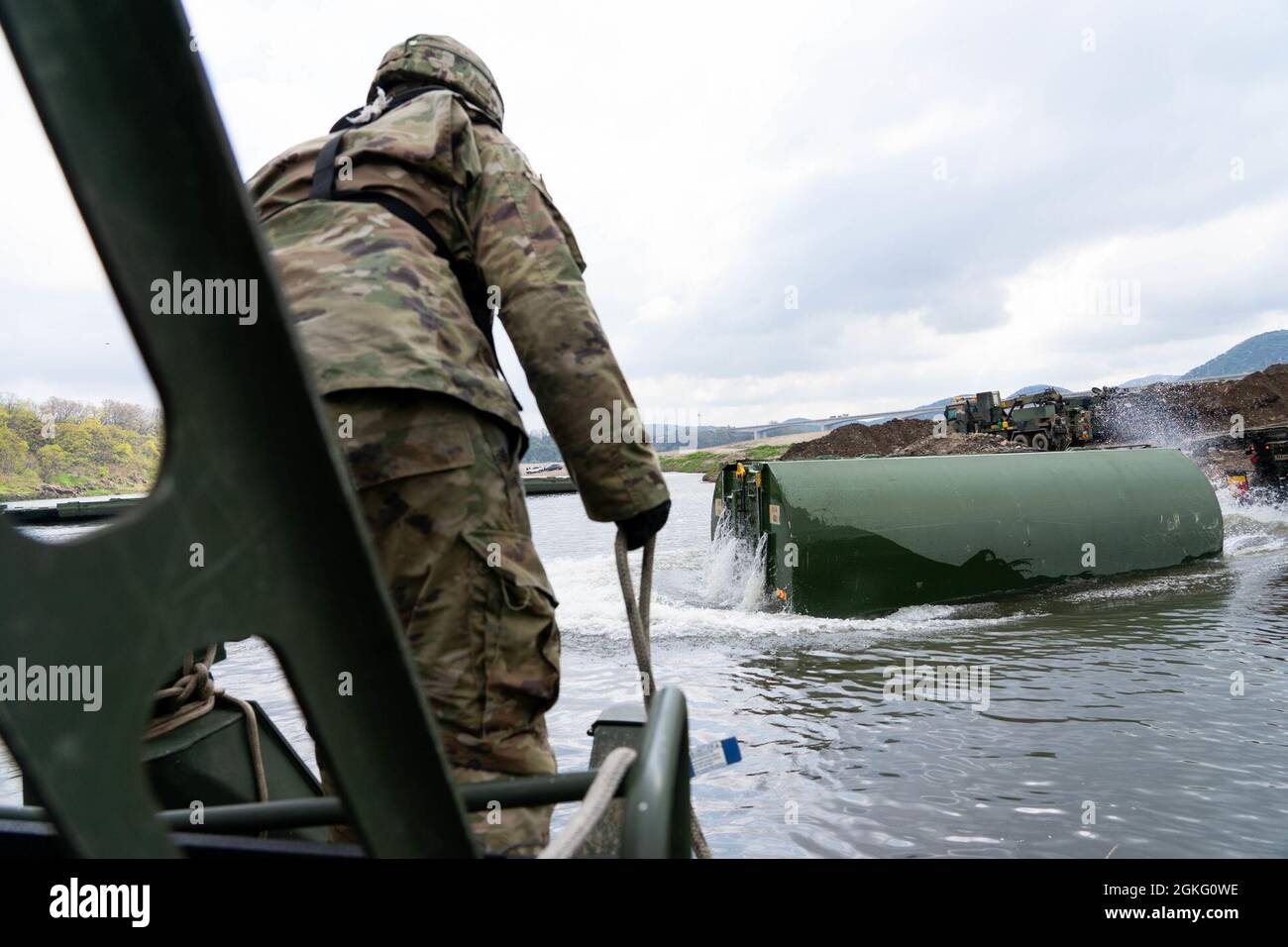 A U.S. Soldier assigned to 2nd Infantry Division watches as a floating ...