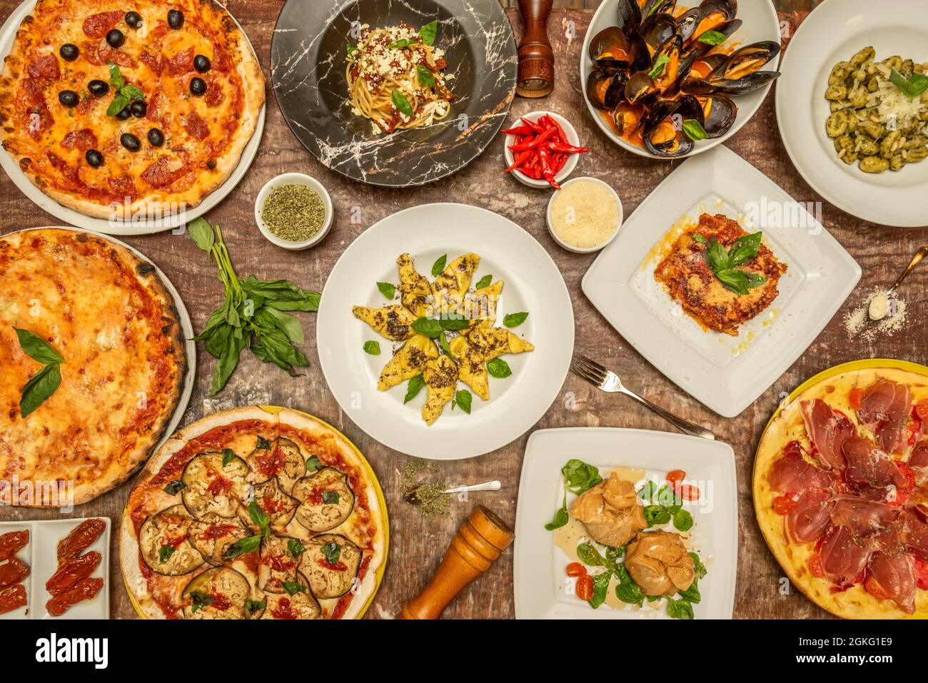 Top view image of typical Italian dishes with lots of basil, pizzas ...