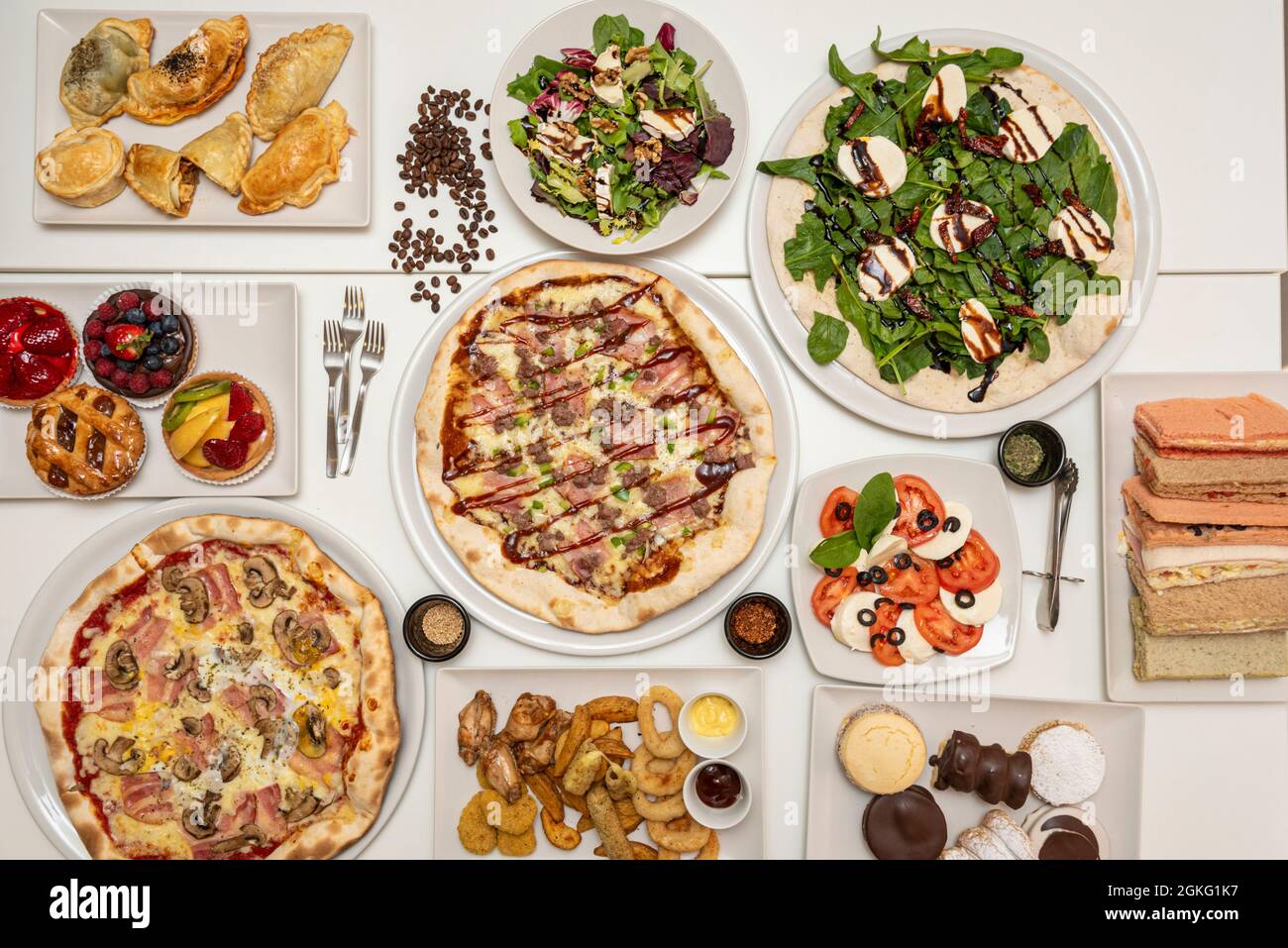 Composition with plates of pizza, tartlets, salads, sandwiches ...