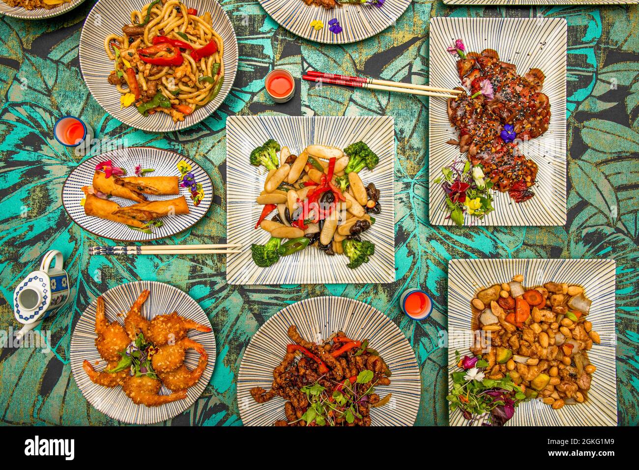 set of chinese food dishes in a restaurant. Rice pasta tongues, chicken ...