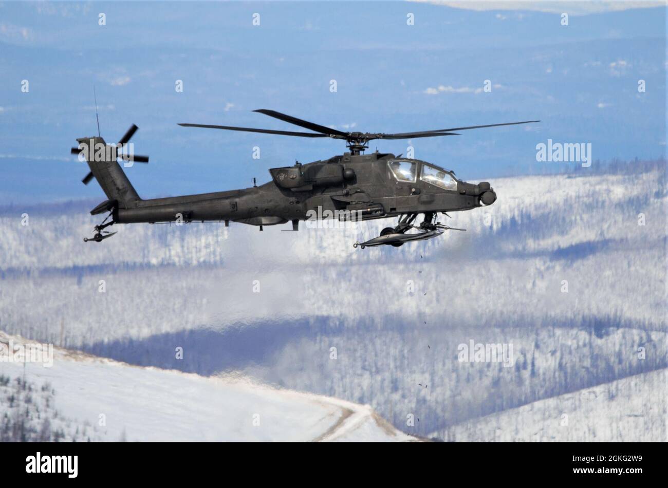 Shell casings from 30mm rounds fall from an AH-64 Apache with 1st ...