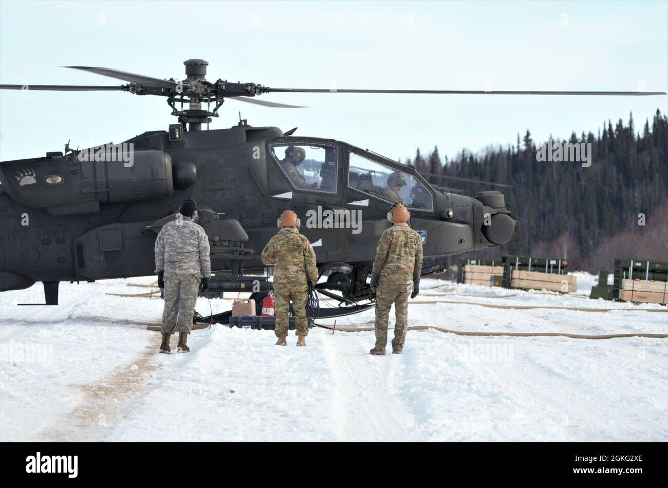 Ground crew members approach an AH-64 Apache with 1st Attack ...