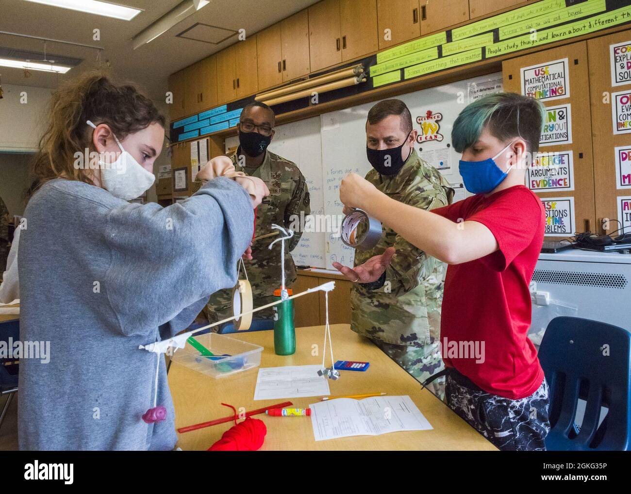Students from the Sollars Elementary School, receive help from U.S. Air ...