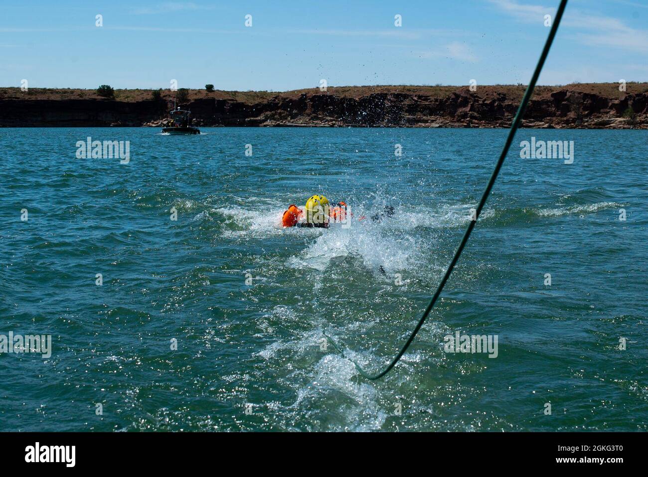 An Airman wades in the water before being dragged behind a boat during ...