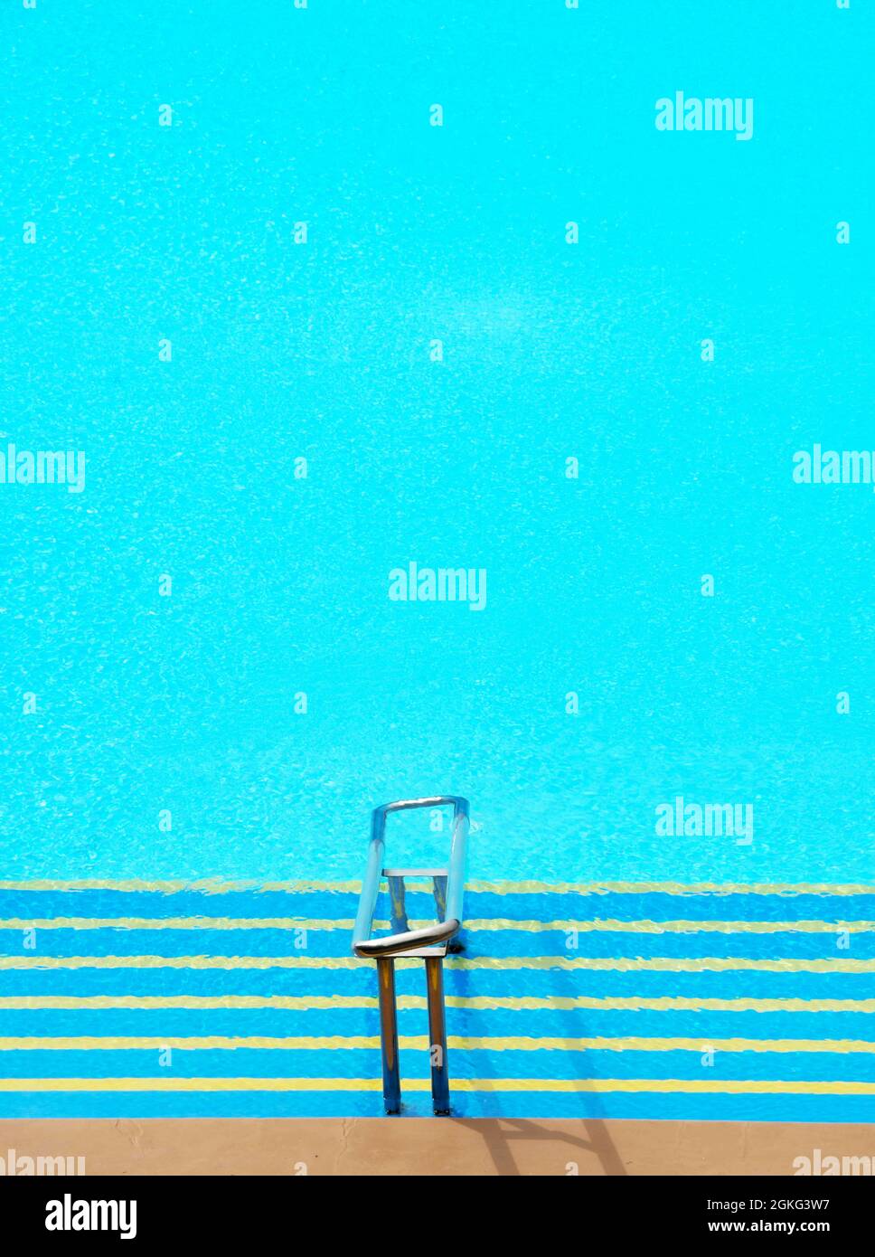 Steps and handrail leading into an outdoor swimming pool. No people ...