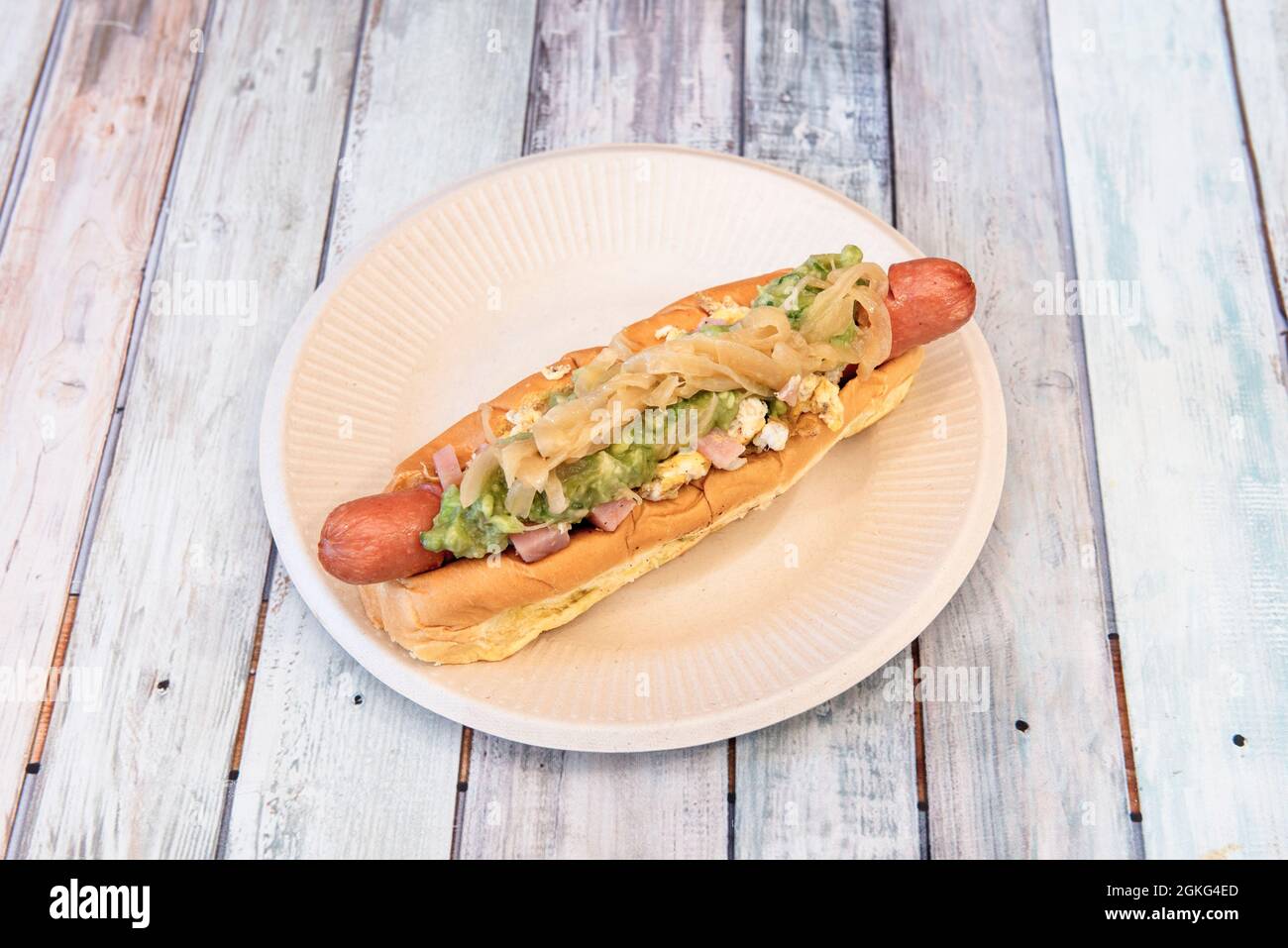 Hot dog with avocado, onion, ham and boiled egg on paper plate Stock ...