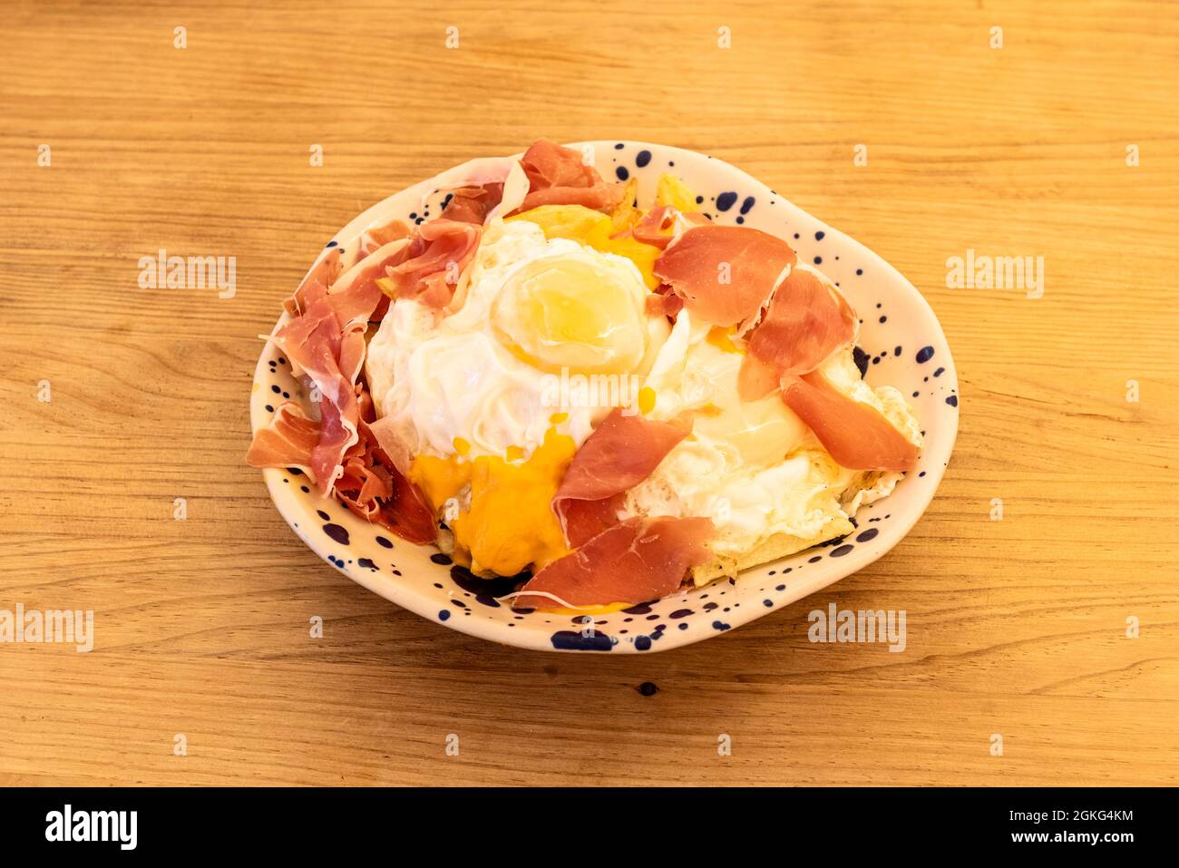 Famous Spanish dish of broken eggs with Serrano ham to share tapas ...