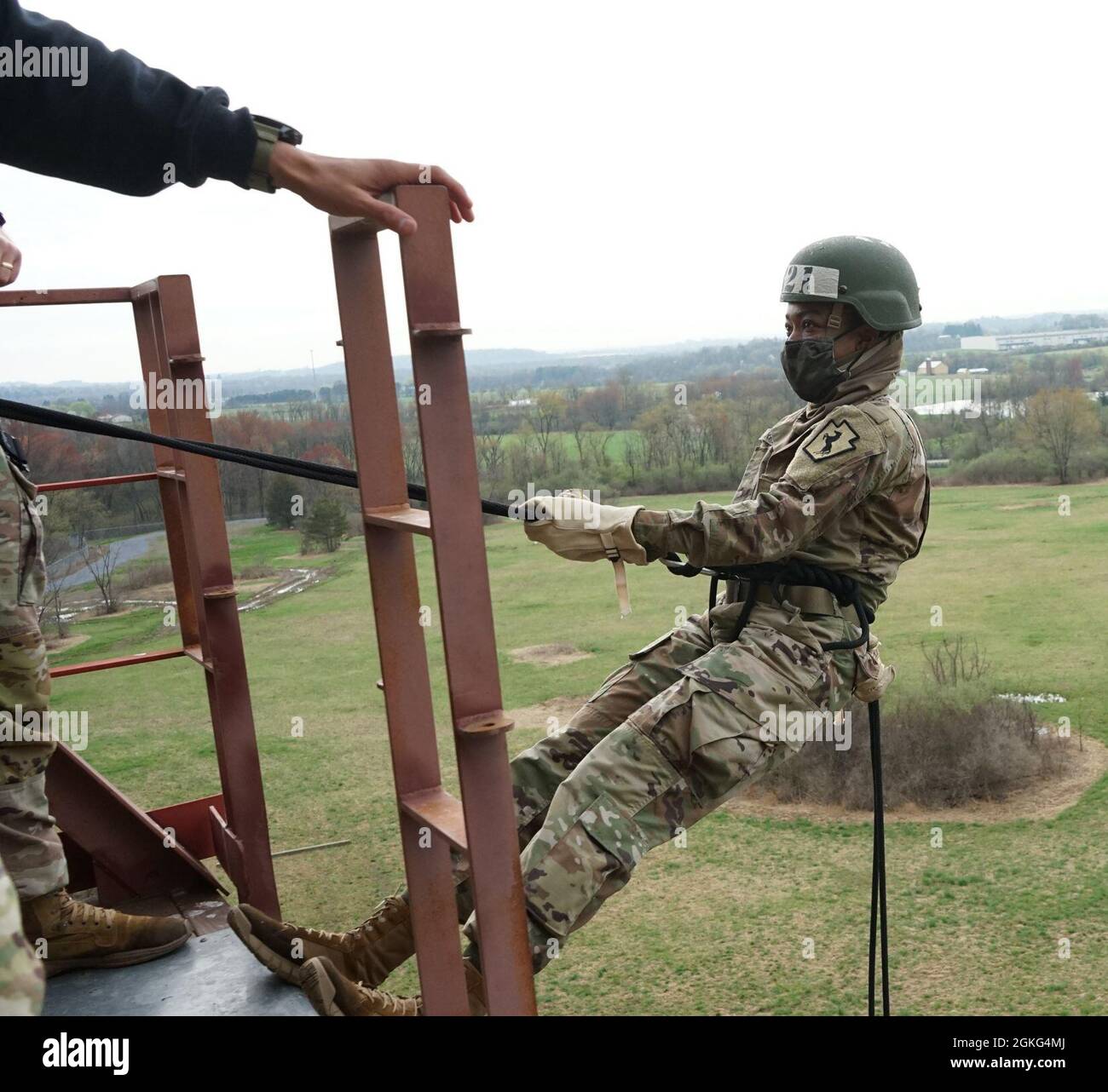 A Soldier in the Air Assault class walks onto the ledge and waits for ...