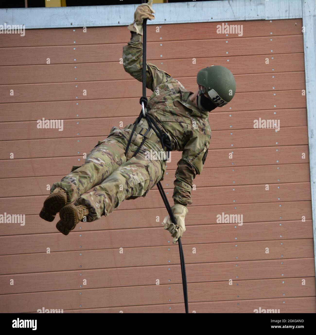 A Soldier forms an “L-position” as they descend the rappel tower during ...