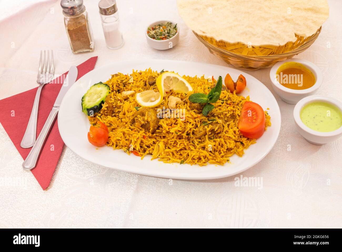 Tray of biryani rice stewed with lamb meat and vegetables cooked in a ...