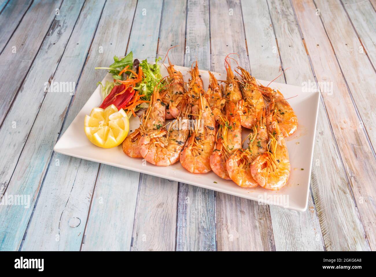 Tray of great grilled fried prawns with spurts of lemon, garlic and ...