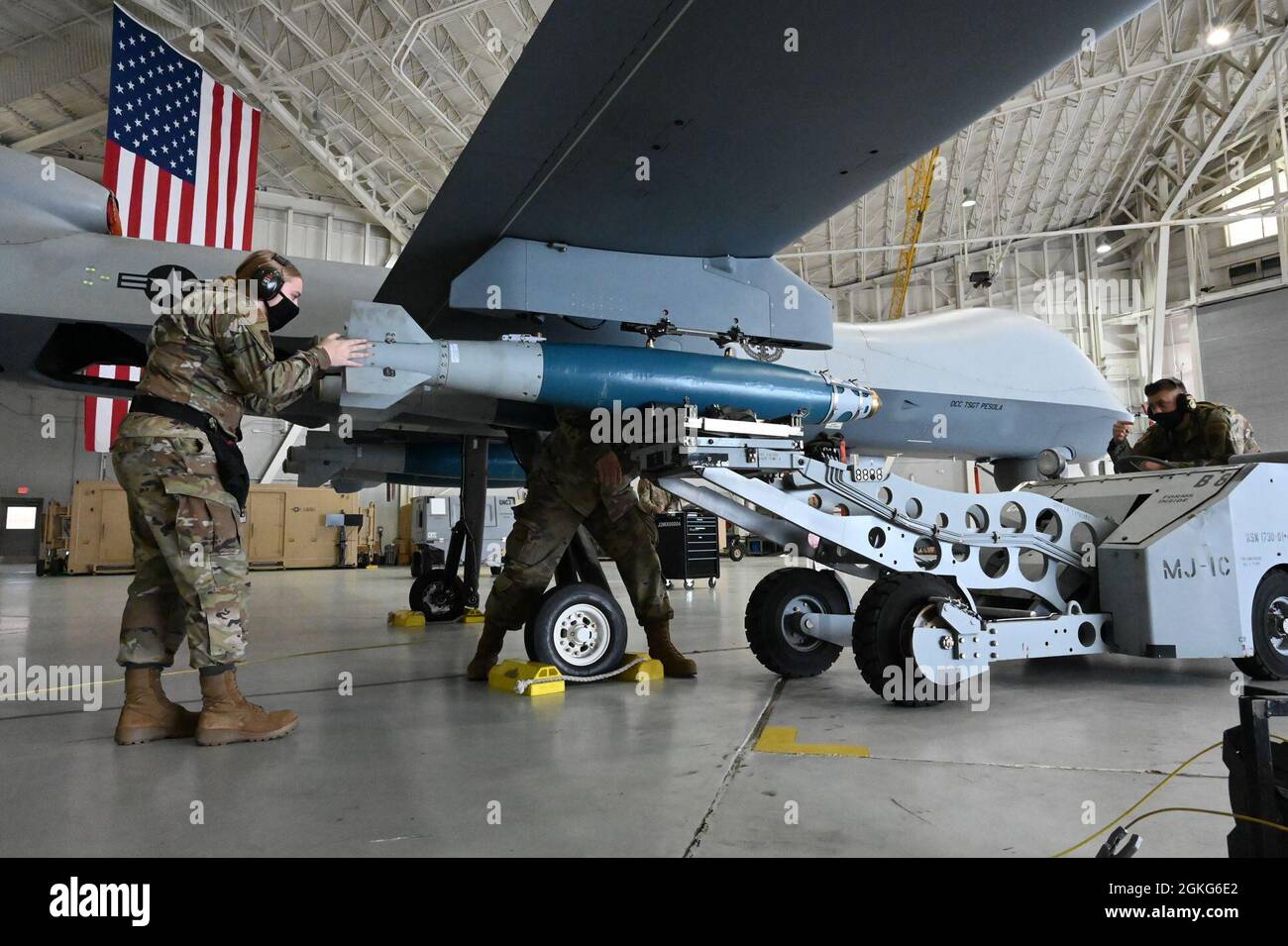 Airmen from the 119th Aircraft Maintenance Squadron, North Dakota Air National Guard, load inert ...