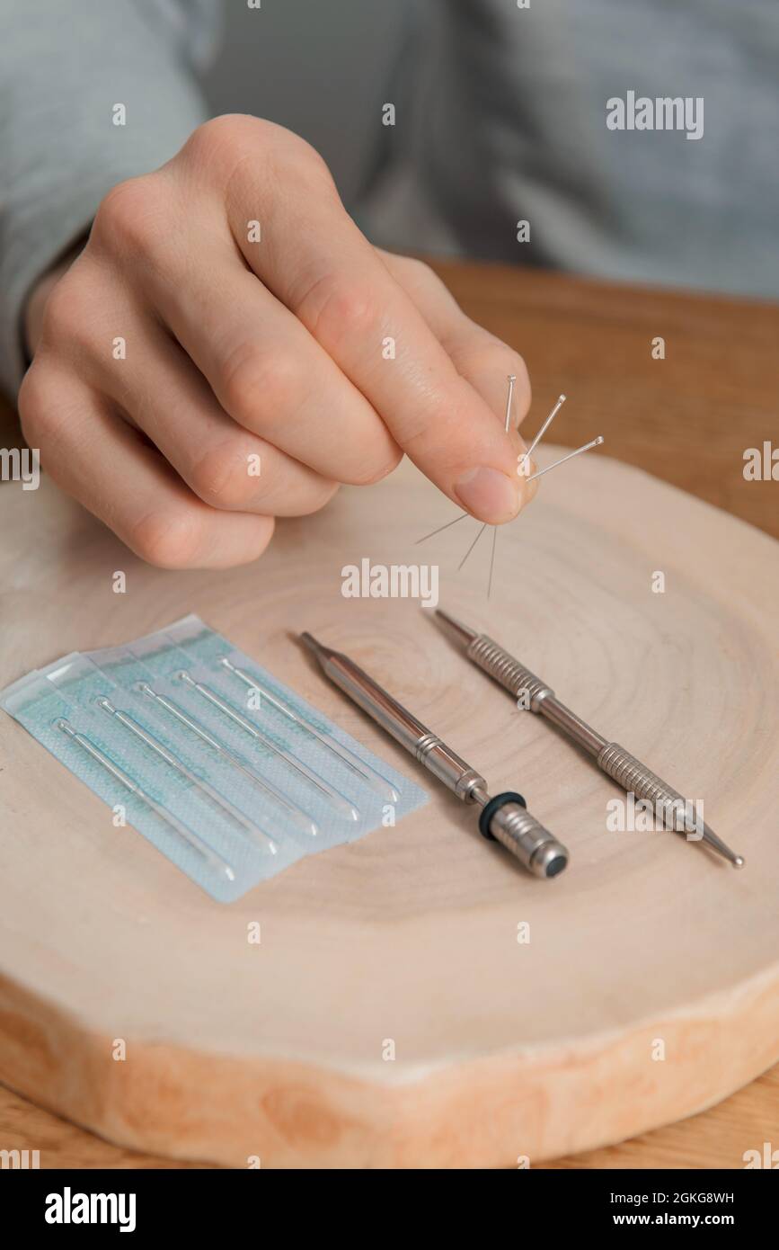 Acupuncture treatment on man's hands. Rehabilitation using alternative ...