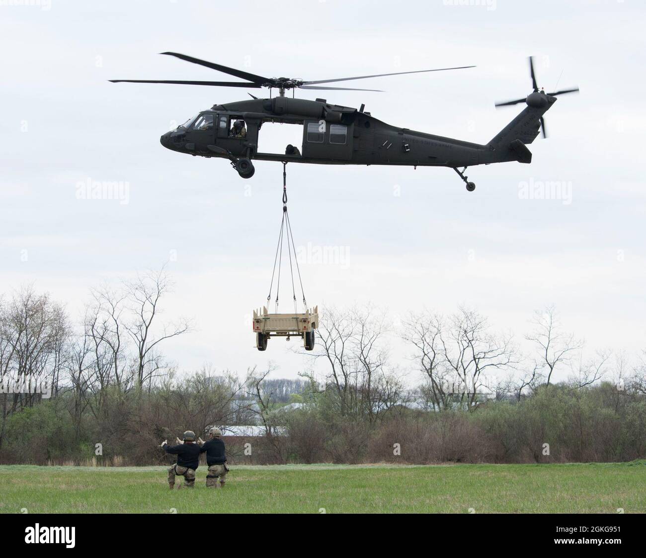 After attaching the sling load, the UH-60 Black Hawk helicopter rises ...