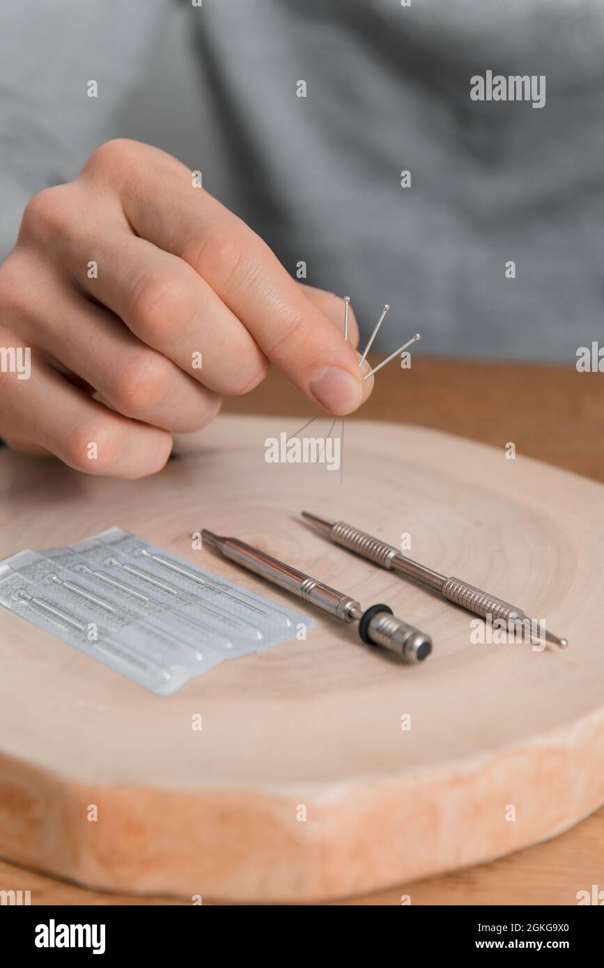 Acupuncture treatment on man's hands. Rehabilitation using alternative ...