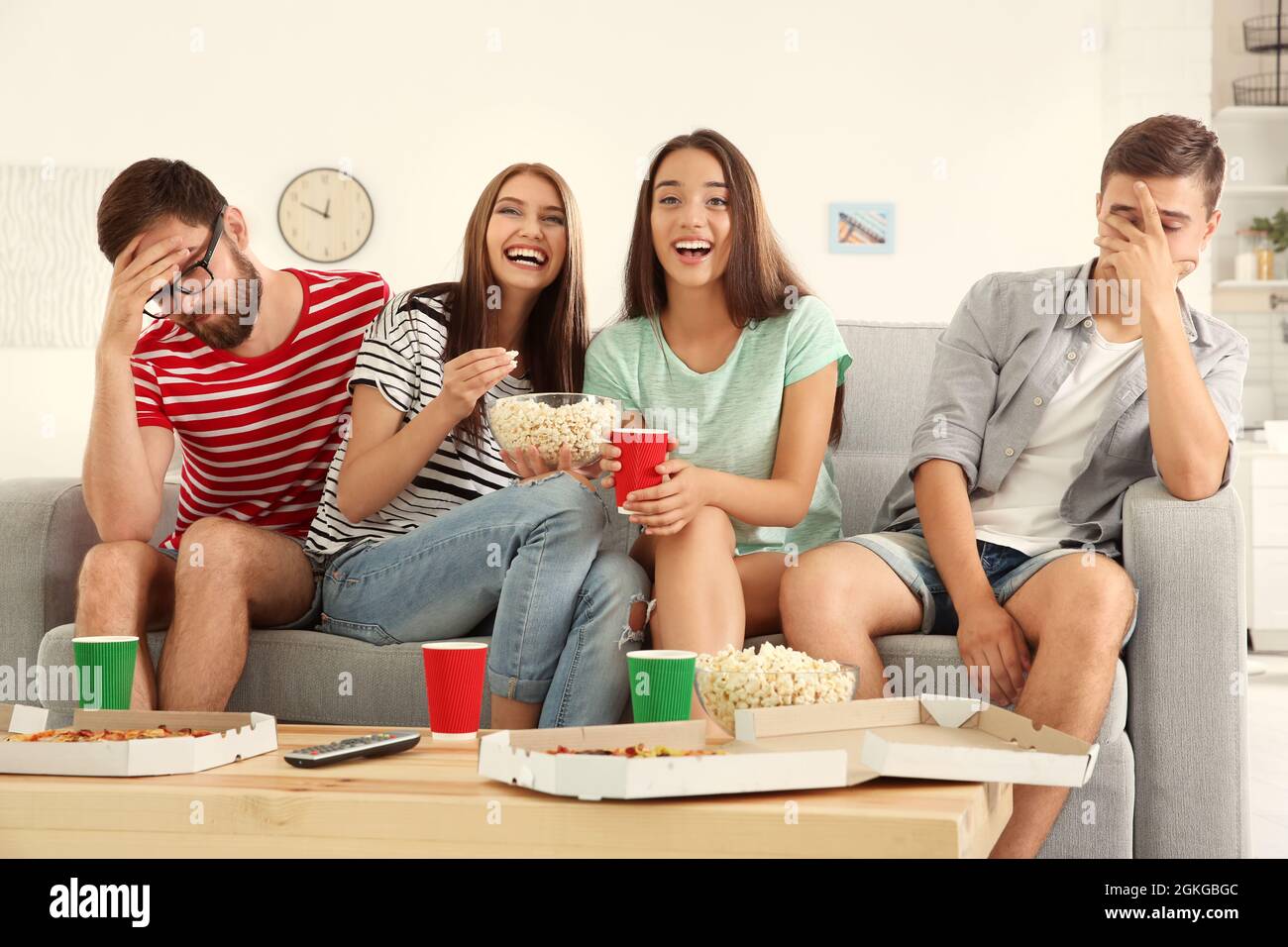 Friends watching TV at home Stock Photo - Alamy