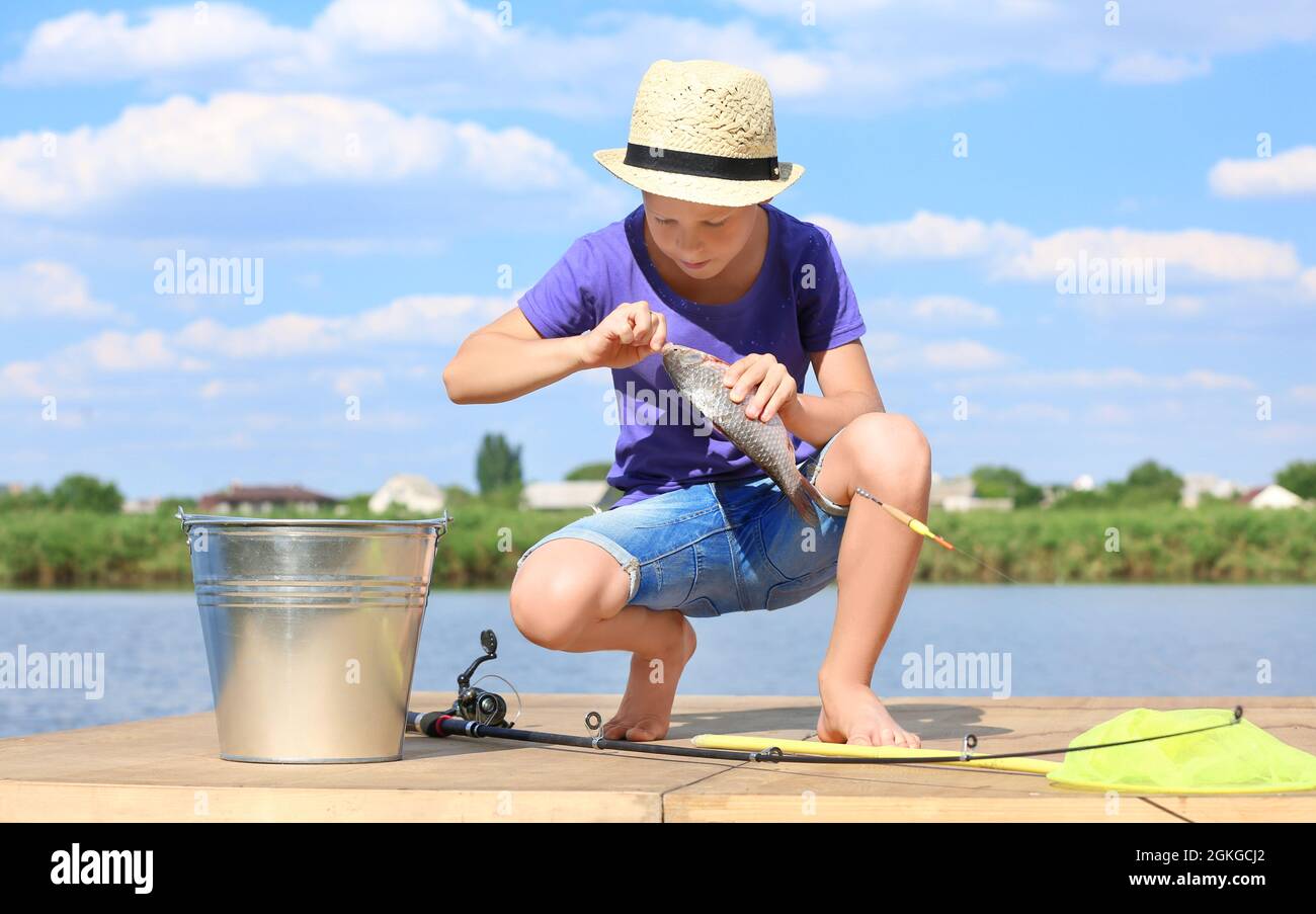 Cute boy fishing on summer day Stock Photo - Alamy