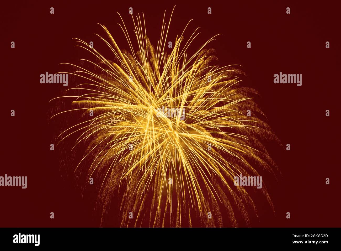 Christmas background: yellow fireworks against dark red background ...