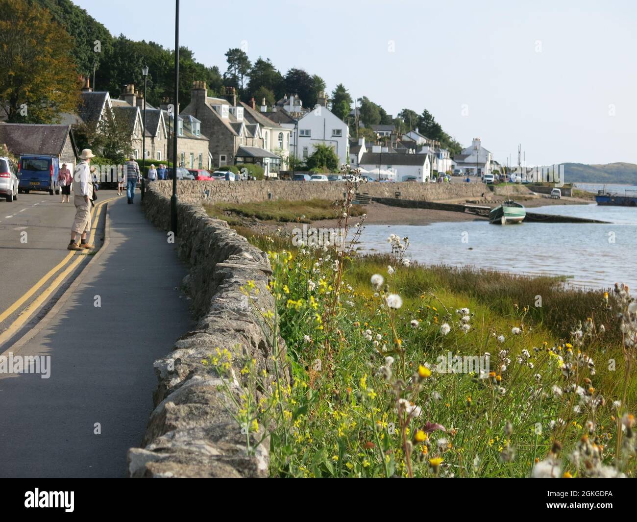 View of the coastal road through the village of Kippford, overlooking ...