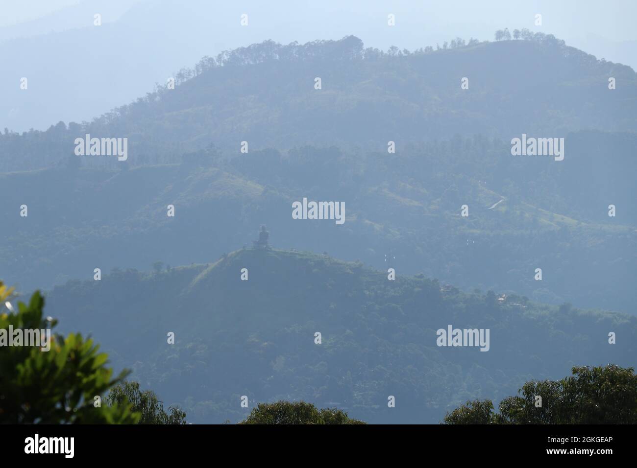 Misty view of the mountains with hidden Buddha statue Stock Photo - Alamy