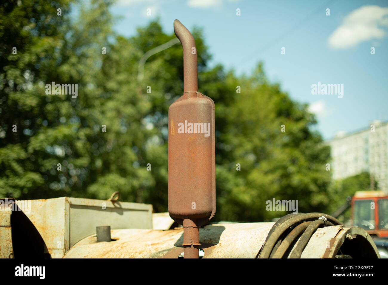 Rusty diesel engine pipe. Muffler on the engine. Rusty metal at the car ...
