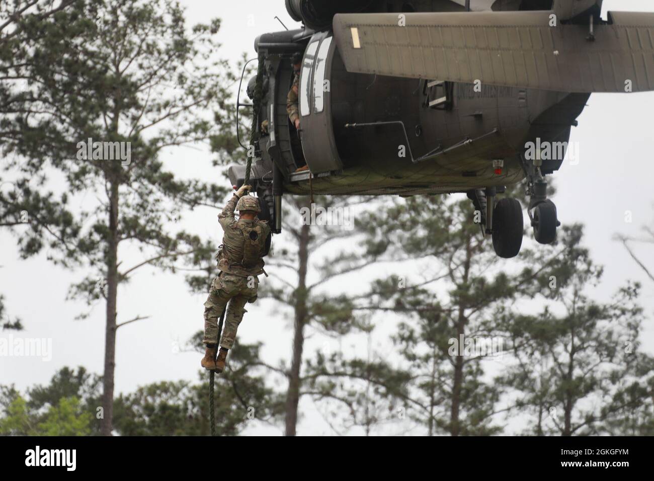 United States Army Rangers jump out of a Black Hawk onto a firing range ...