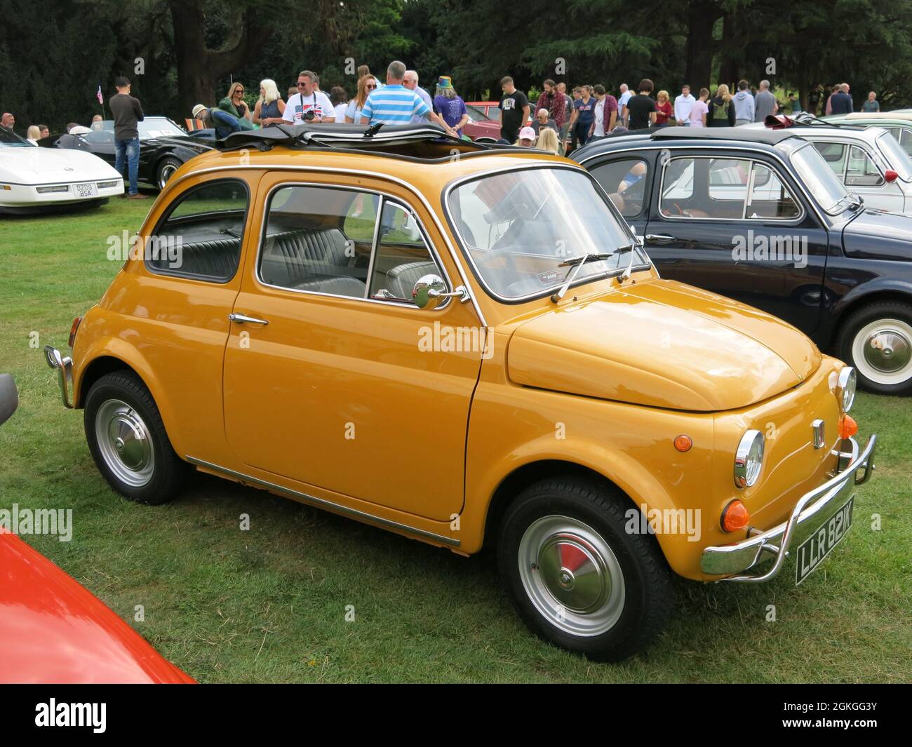 A bright orange Fiat 500 with immaculate paintwork, on display at the ...