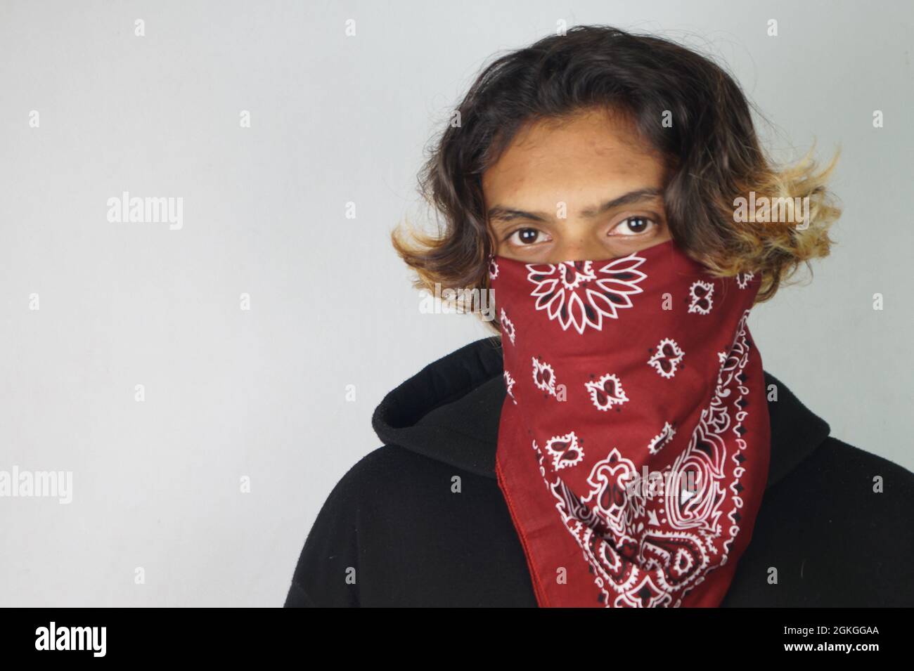 Young thug Indian male with a bandana covering his face Stock Photo - Alamy