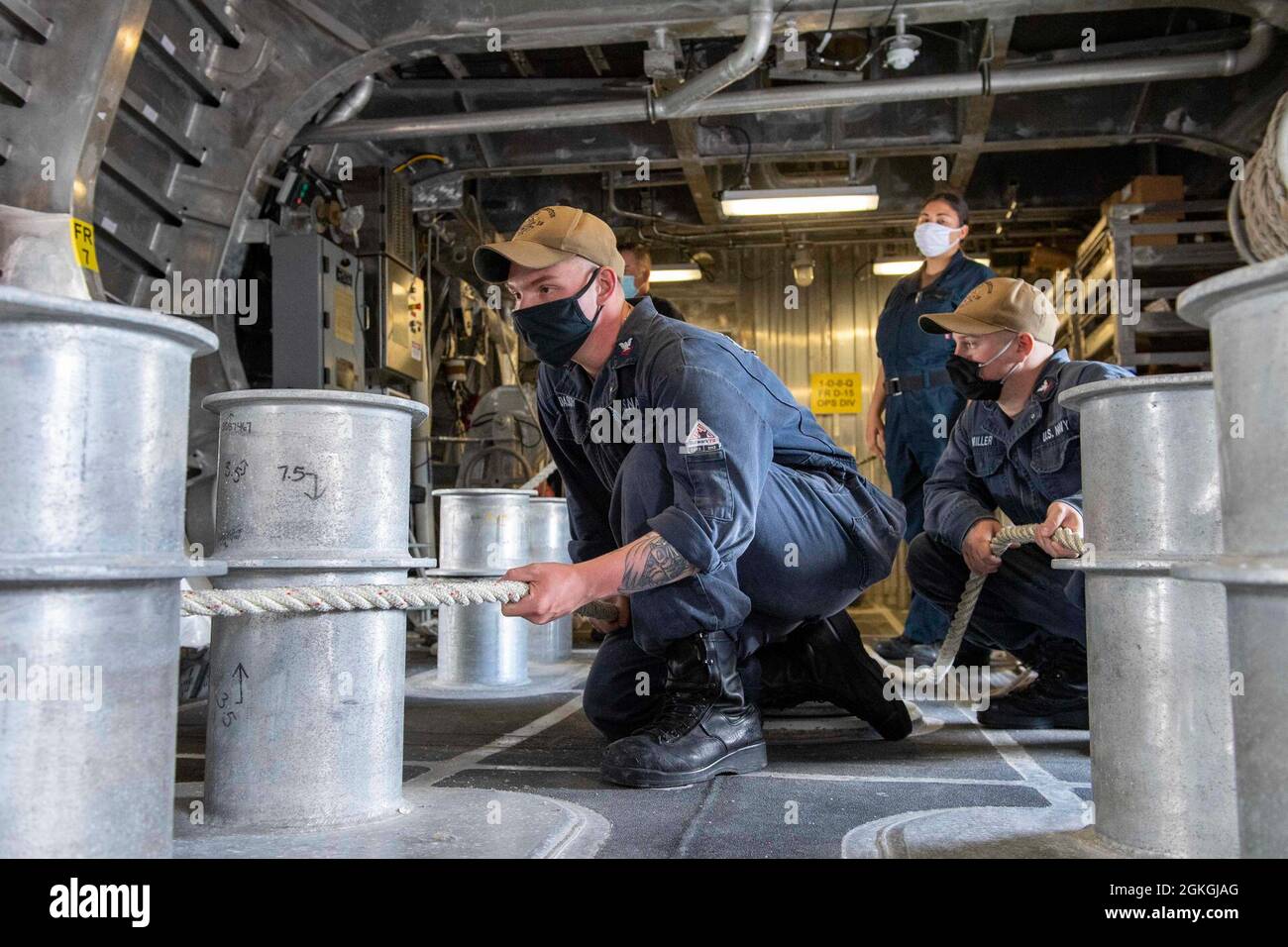 PACIFIC OCEAN (April 16, 2021) A team of Sailors handle a line aboard ...