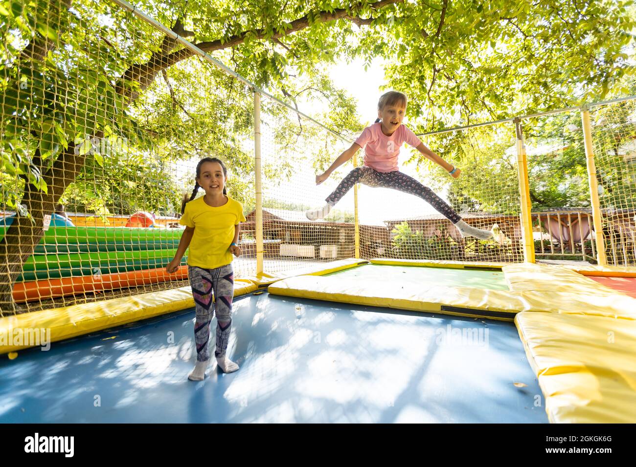 Happy children jumping on trampoline Stock Photo - Alamy