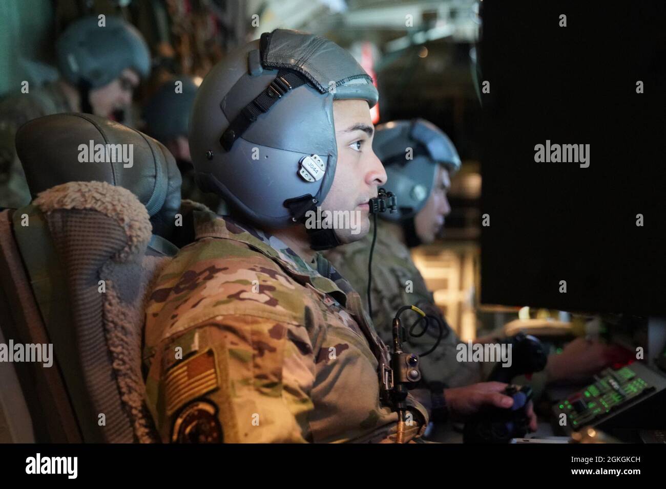 A sensor operator takes aim from an AC-130J Ghostrider gunship over a ...