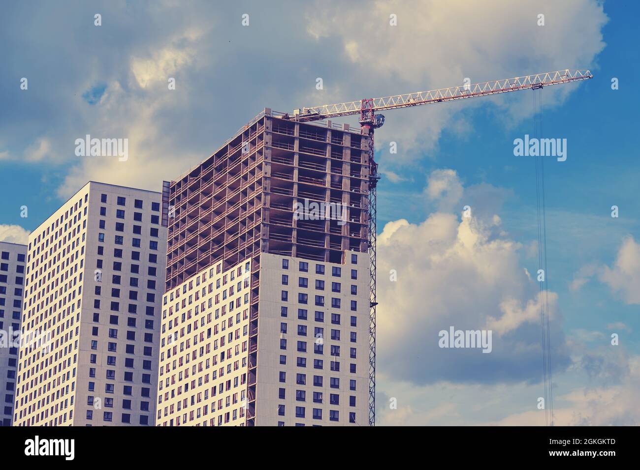 Unfinished modern high-rise houses against the blue sky Stock Photo - Alamy