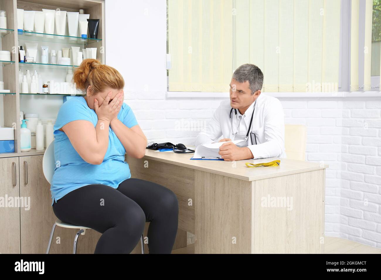 Overweight woman having consultation at doctor's office Stock Photo - Alamy