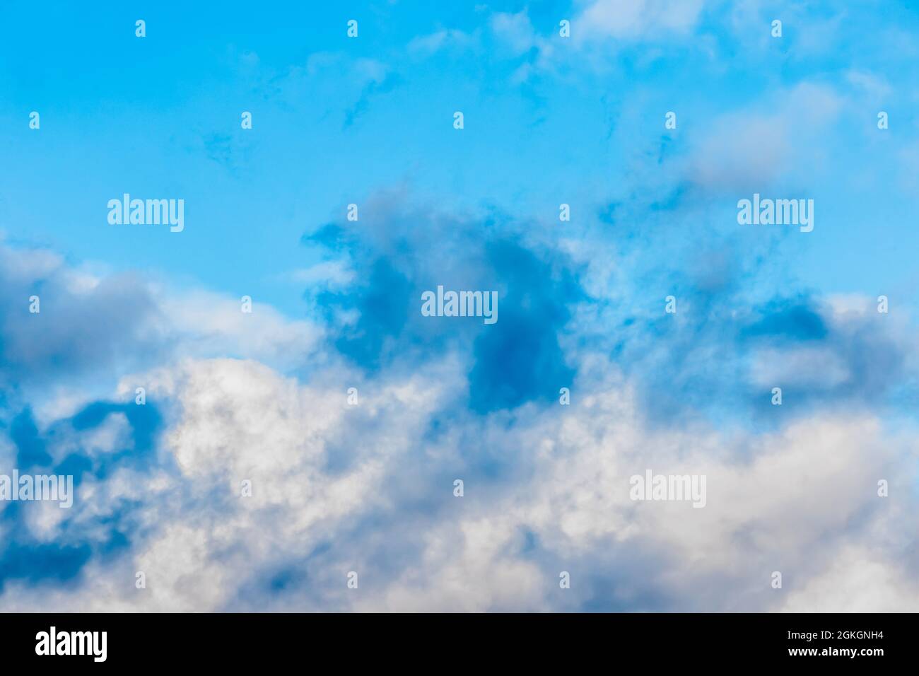 Blue sky air texture with soft white clouds background Stock Photo - Alamy