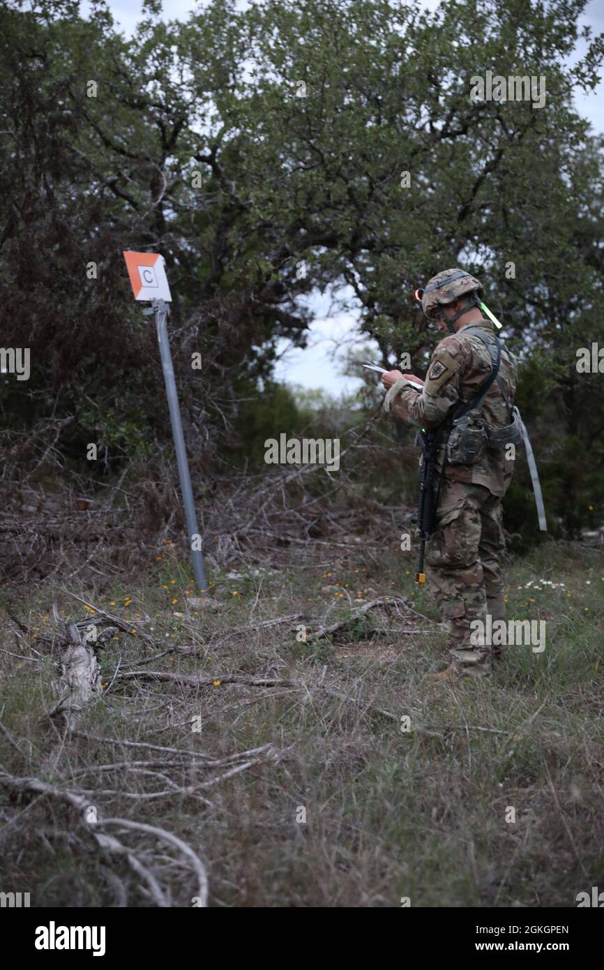 Spc. Karhl Wayman plans his next actions after locating a map point ...