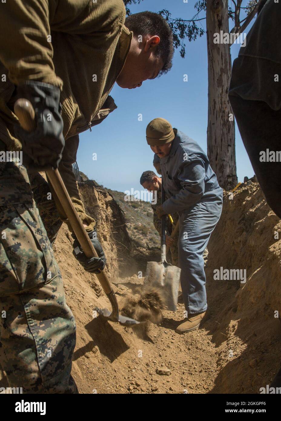 U.S. Marines with Marine Wing Support Squadron (MWSS) 373, shovel away ...