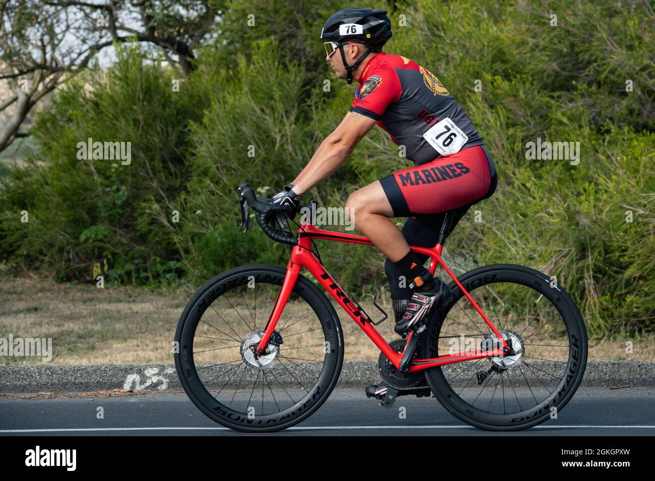 U.S. Marine Corps Capt. Thomas Benge competes in the cycling time ...