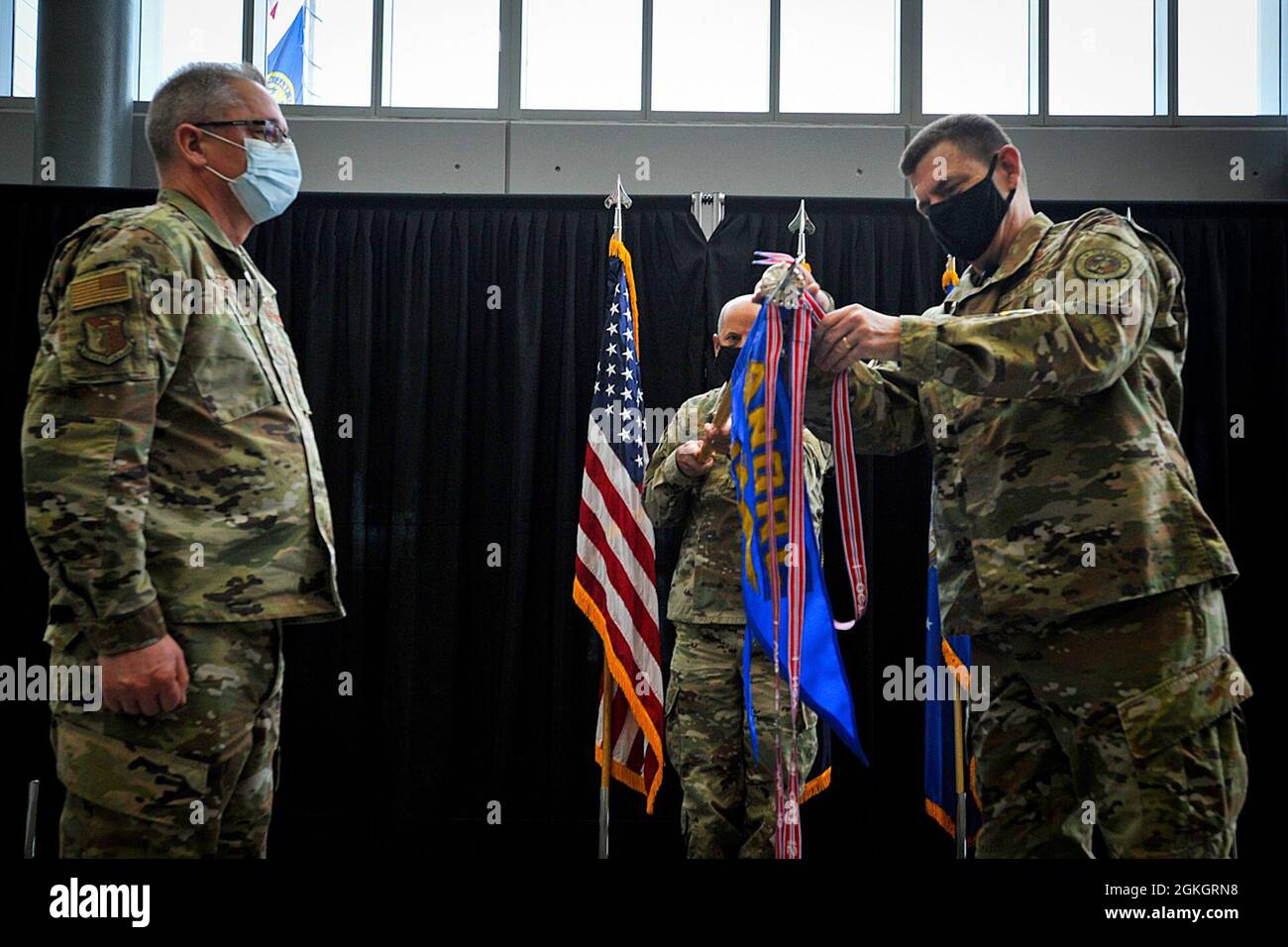 Lt. Gen. Michael Loh, director of the Air National Guard, places a ...