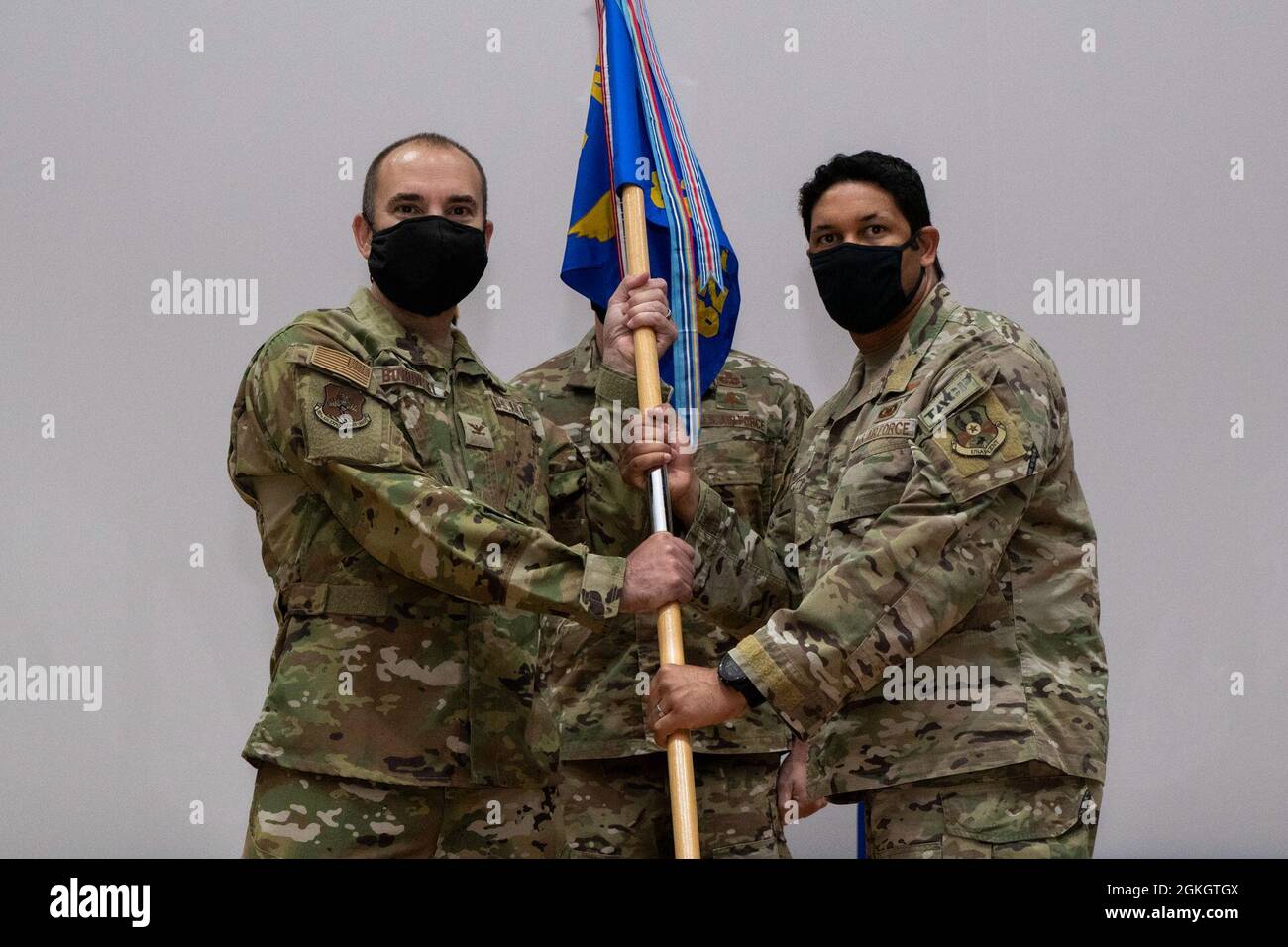 U.S. Air Force Maj. Burley J. Malbrough, receives the guidon from Col ...