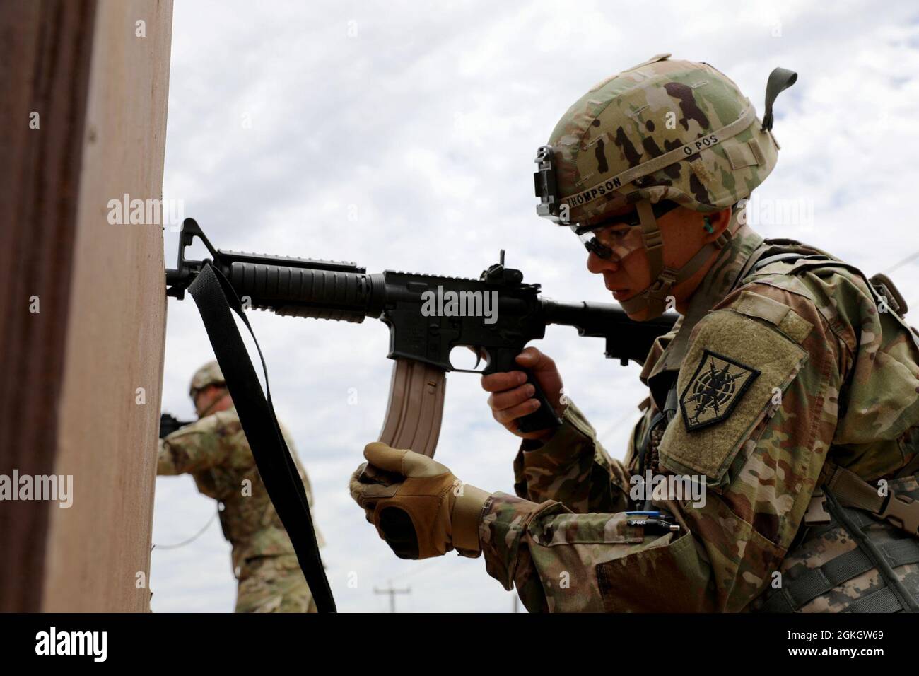 Spc. Christopher Thompson performs a magazine change during the weapon ...