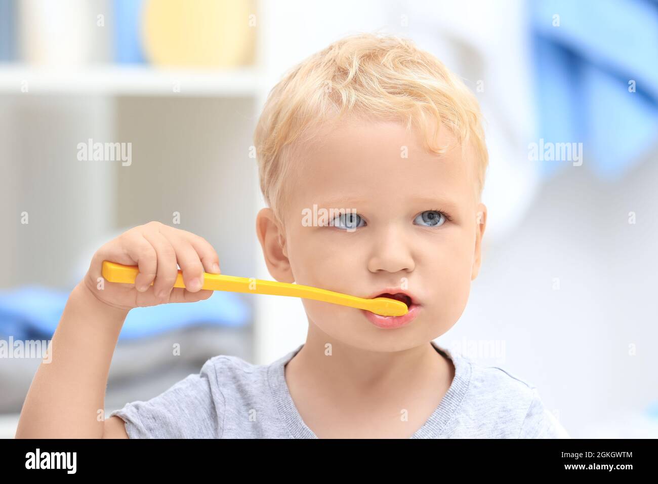 Cute little child cleaning teeth in bathroom Stock Photo - Alamy