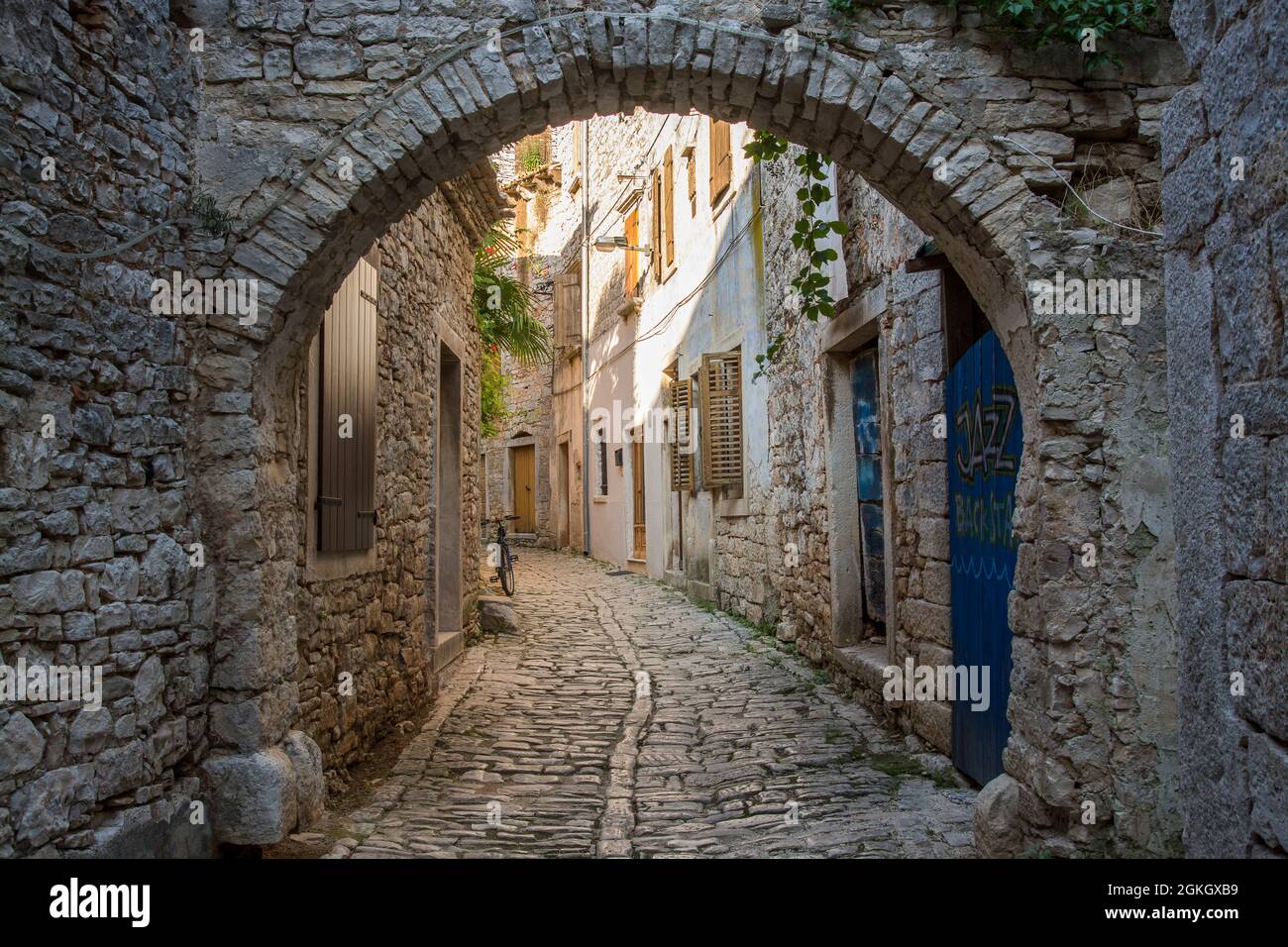 Quiet cobblestone arch and narrow old street of Bale, Istria, Croatia ...