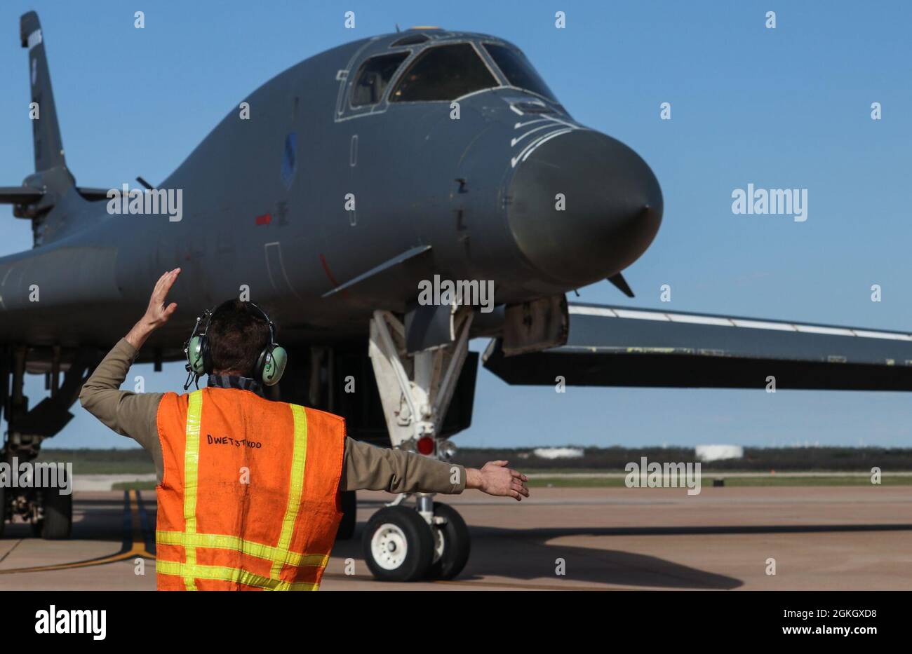 A member of the 7th Equipment Maintenance Squadron marshals a B-1B Lancer at Dyess Air Force ...