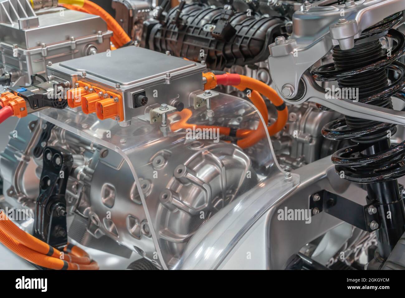 Detailed closeup of an electric car engine and spare parts with orange ...
