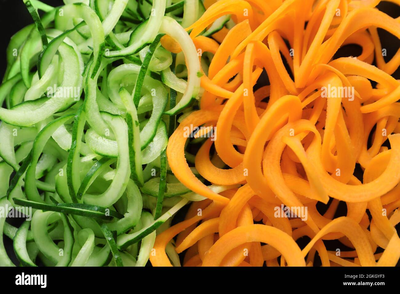 Raw cucumber and carrot spaghetti, close up Stock Photo - Alamy