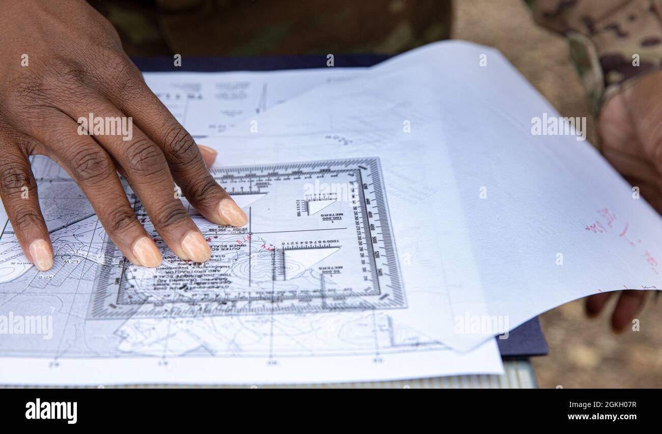 U.S. Army Capt. Delicia Battle measuring map coordinates for land ...