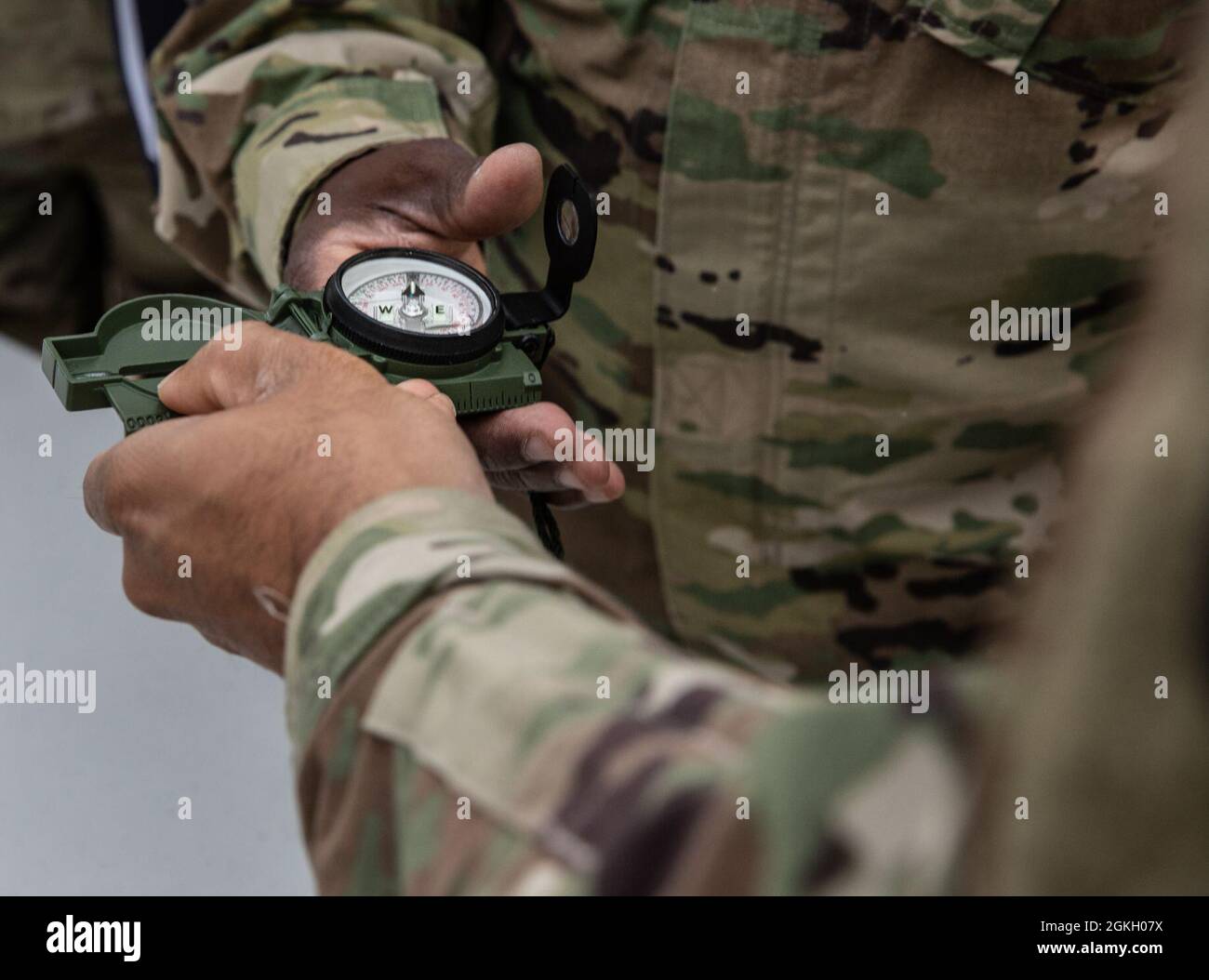 U.S. Army Soldiers share a compass during land navigation in one of the ...